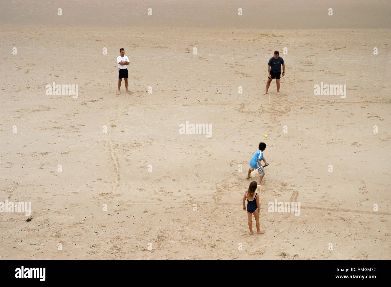 Family cricket on the beach Stock Photo - Alamy