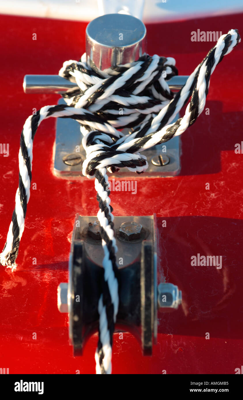 Close up of rope mooring bright red boat to cleat on jetty Stock Photo ...