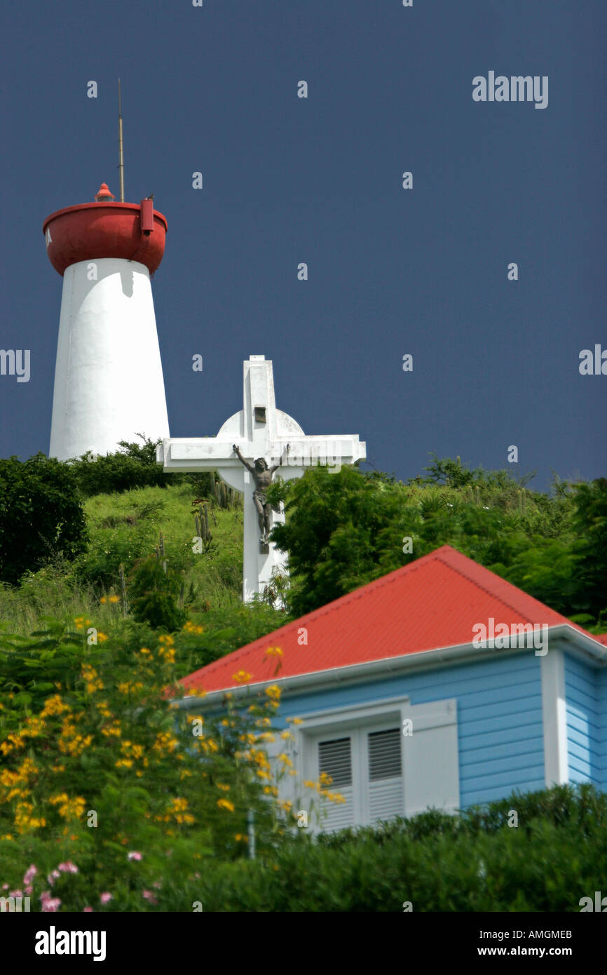 Stone crucifix and lighthouse stand high above Gustavia Harbour St ...