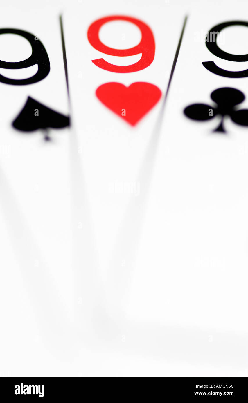 Three nines playing cards Stock Photo - Alamy
