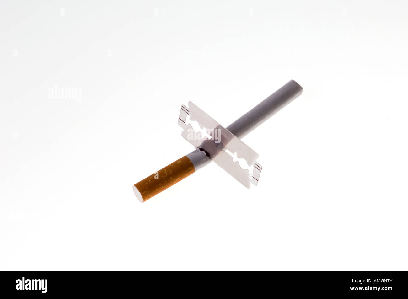 Razor blade cutting cigarette Stock Photo - Alamy