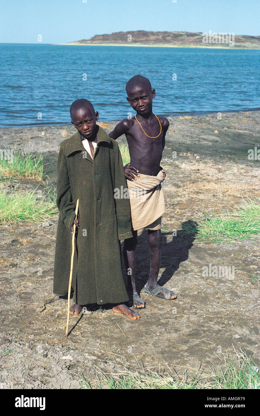 Two El Molo youths one with traditional bare torso and the other ...