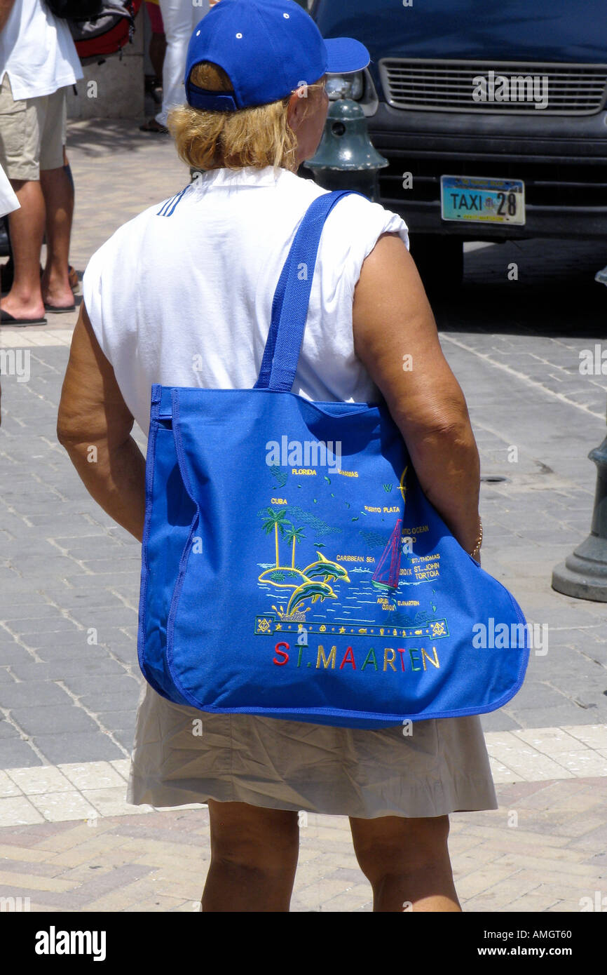 Woman visitor in street wearing cap wiith blue souvenir St Maarten ...