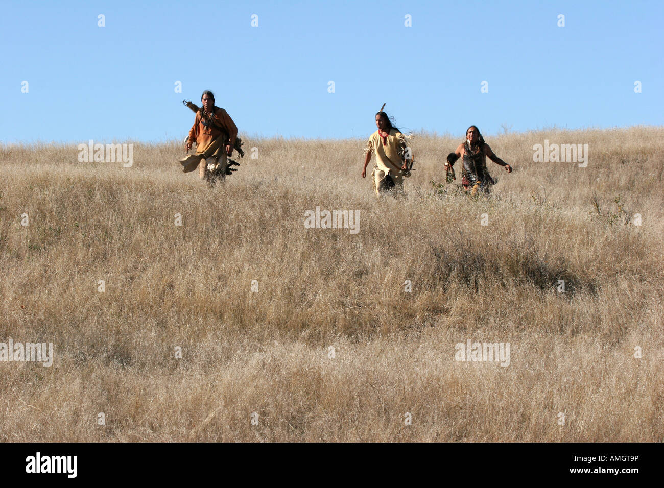 Three Native American Indian men running in the dry grasses Stock Photo ...