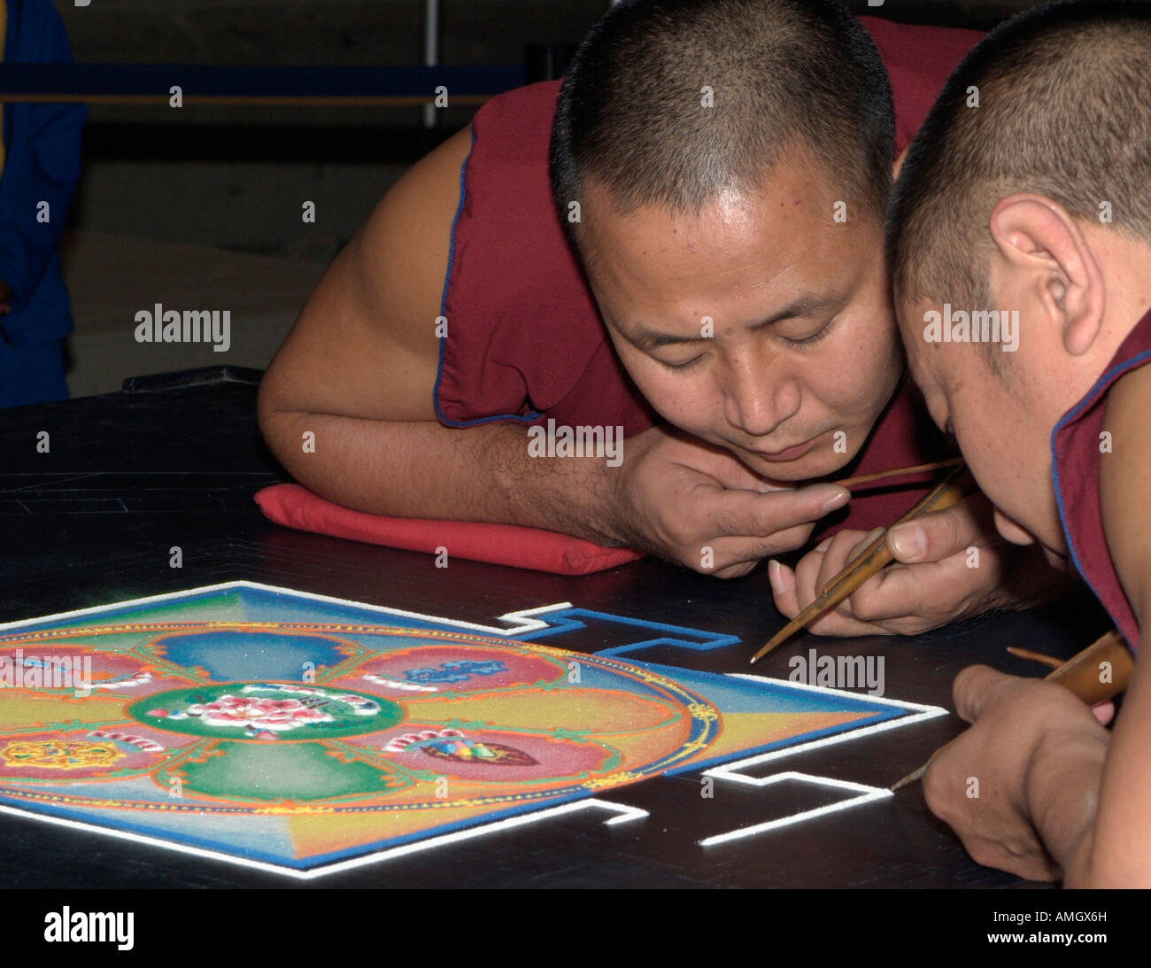 Tibetan buddhist monks create a sand mandala (mandhala), a ...