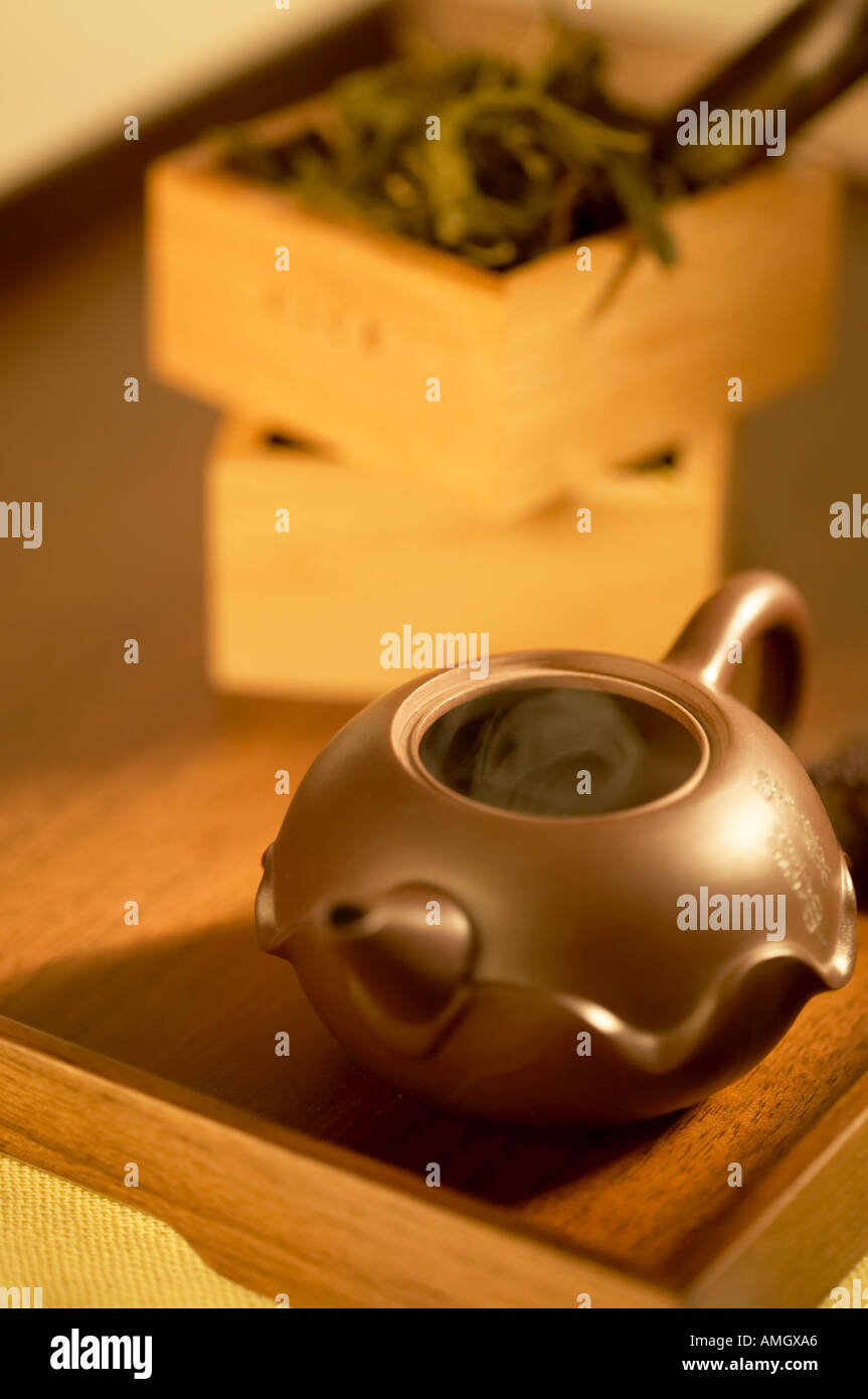 Green tea leaves and teapot Stock Photo - Alamy