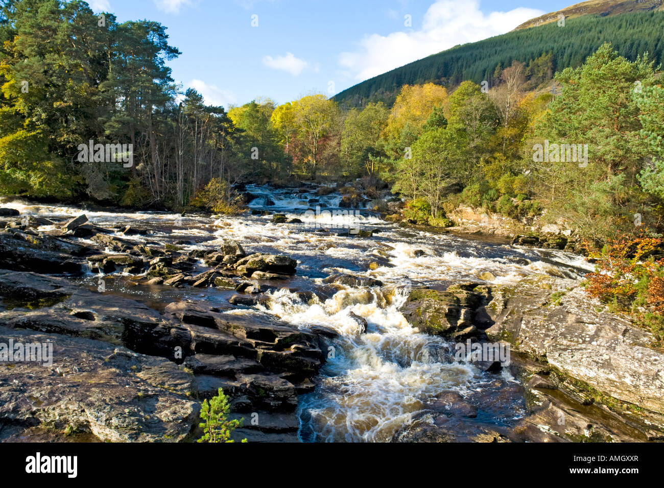 Falls of Dochart rushes through Killin towards Loch Tay on a sunny ...
