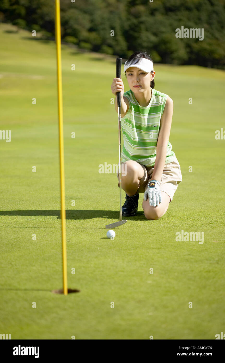 A woman playing golf Stock Photo - Alamy