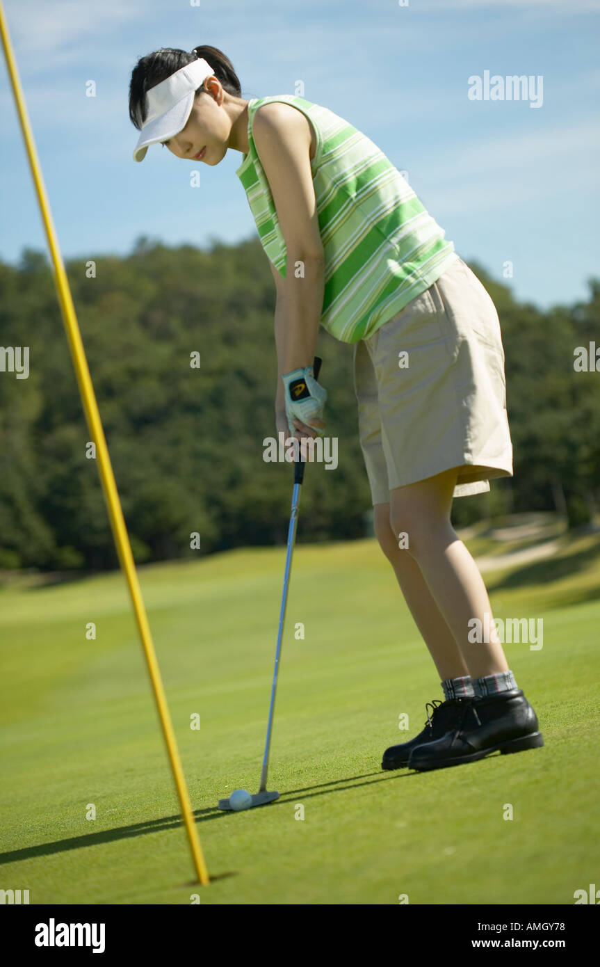 A woman playing golf Stock Photo - Alamy
