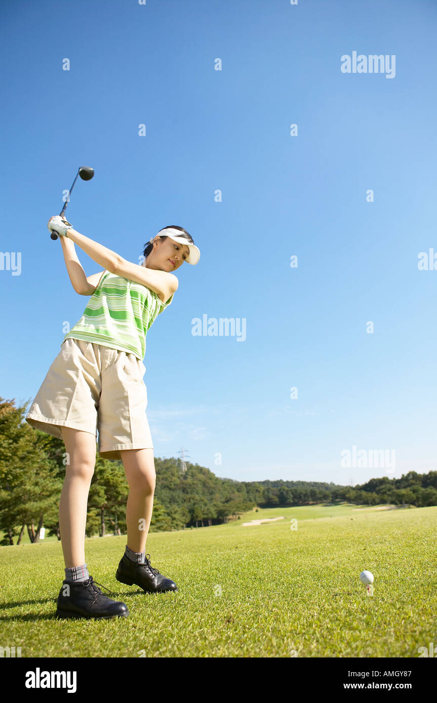 A woman playing golf Stock Photo - Alamy