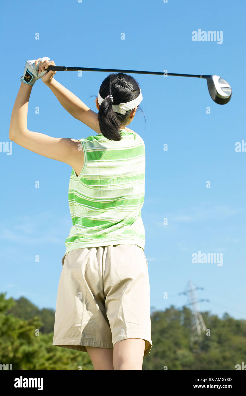 A woman playing golf Stock Photo - Alamy
