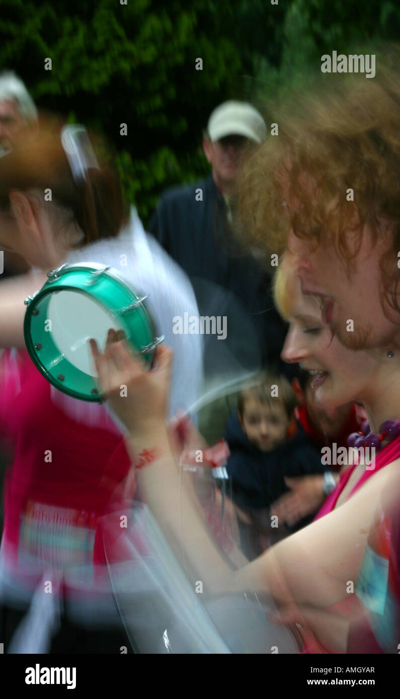 Tambourines shaking with drumsticks Stock Photo - Alamy