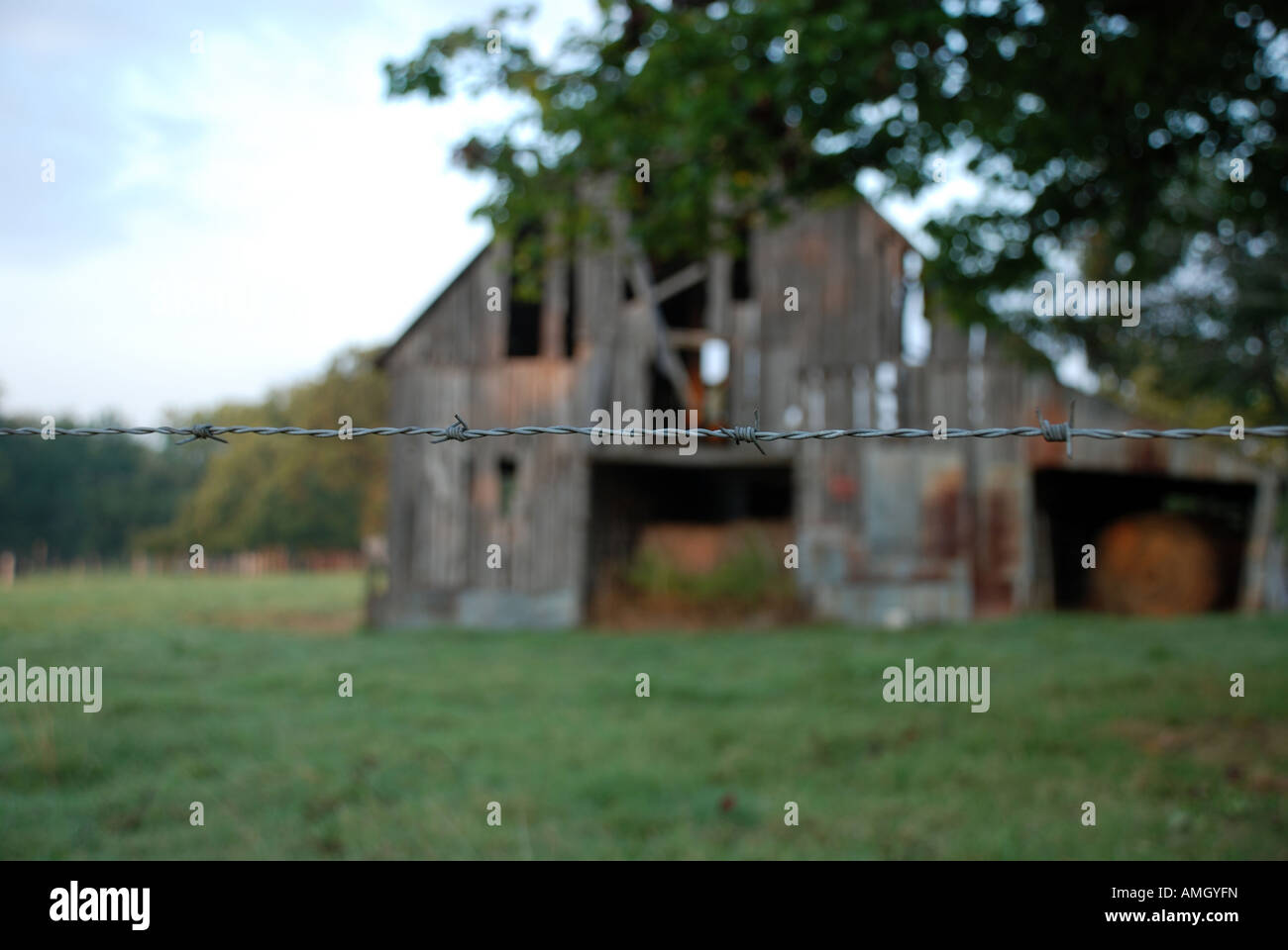 Barbed wire fence and barn Stock Photo - Alamy