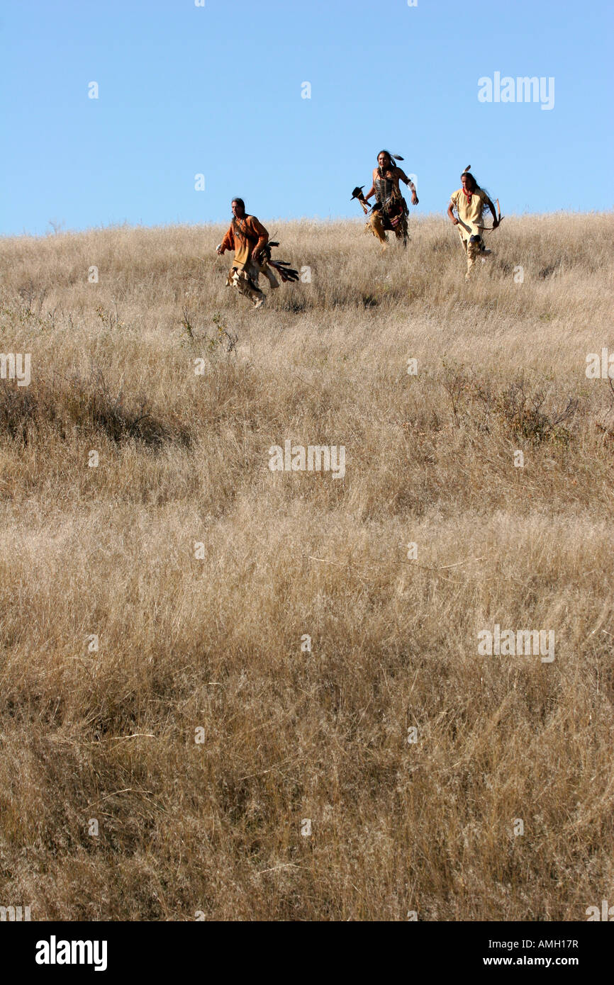 Three Native American Indian men running in the dead grasses Stock ...
