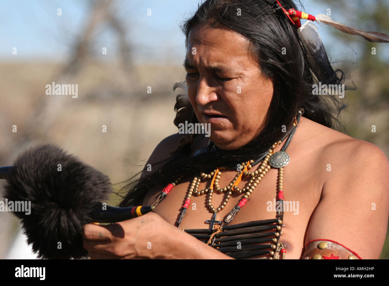 A Native American Indian man looking at his horned club weapon Stock ...