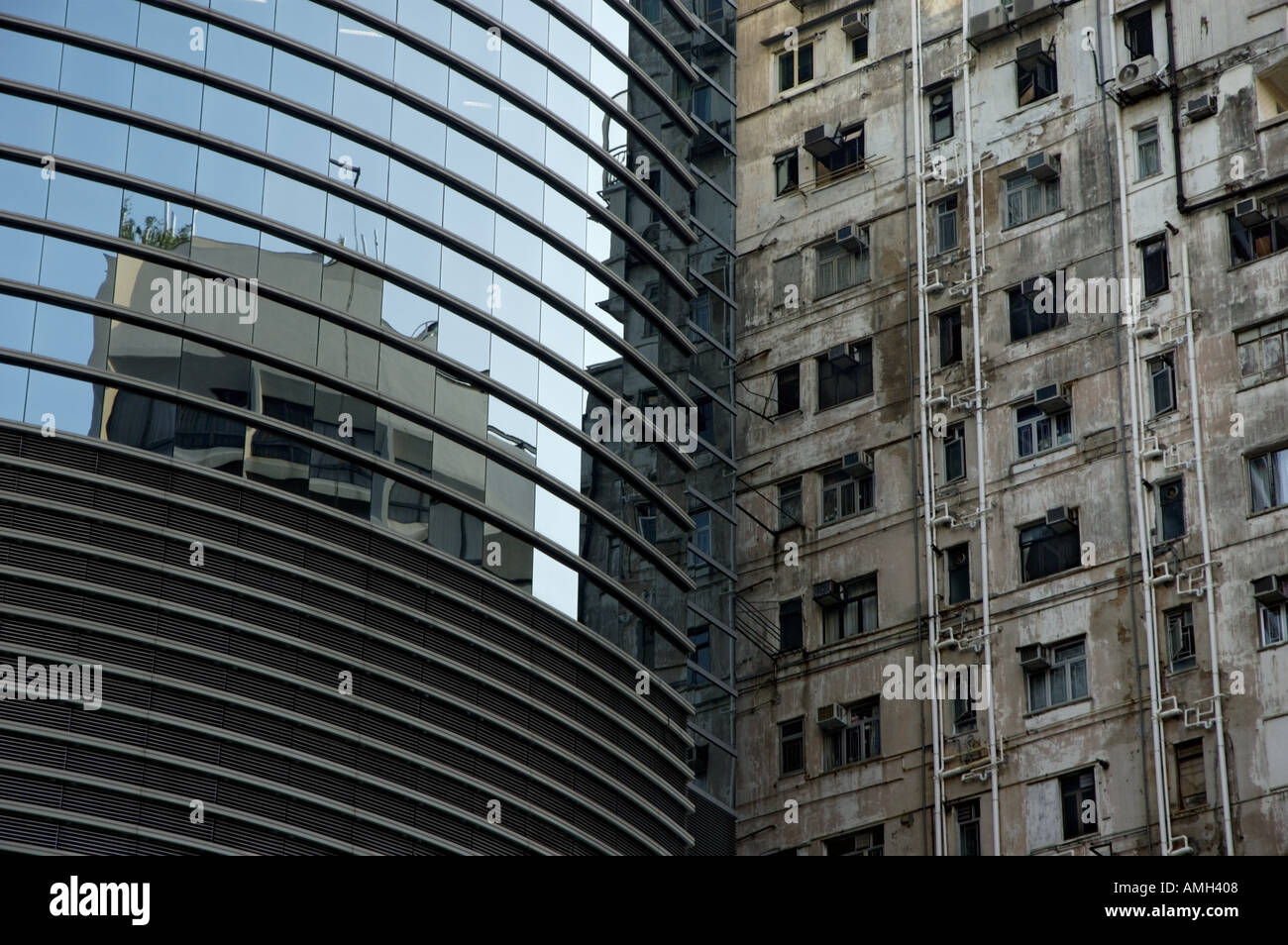 Modern skyscraper juxtaposed beside an old, concrete high-rise building ...
