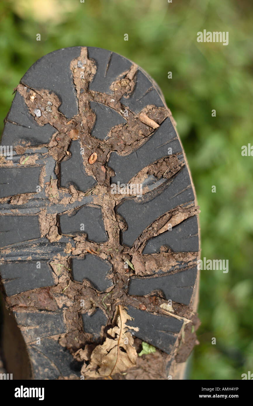 Sole of muddy walking boot Stock Photo - Alamy