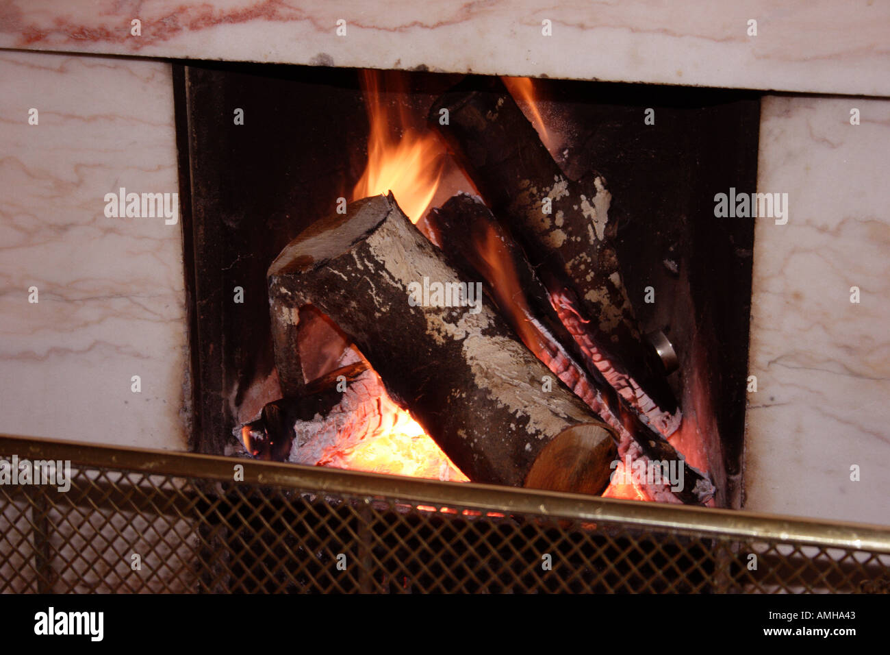 A small interior fireplace wood burning log fire Stock Photo - Alamy