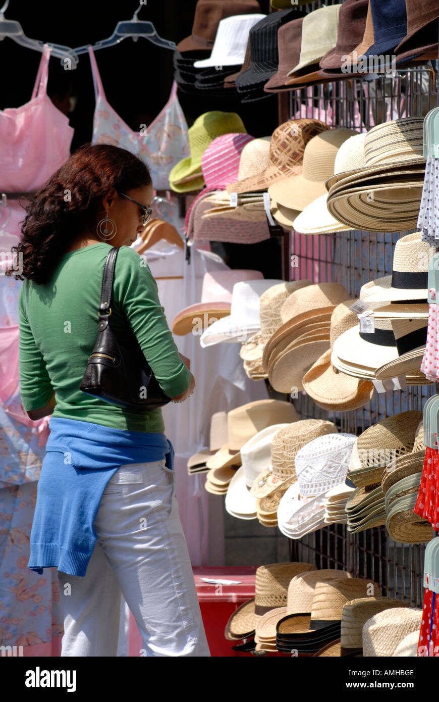 Woman looking at hats on a Strutton Ground street market stall Victoria ...