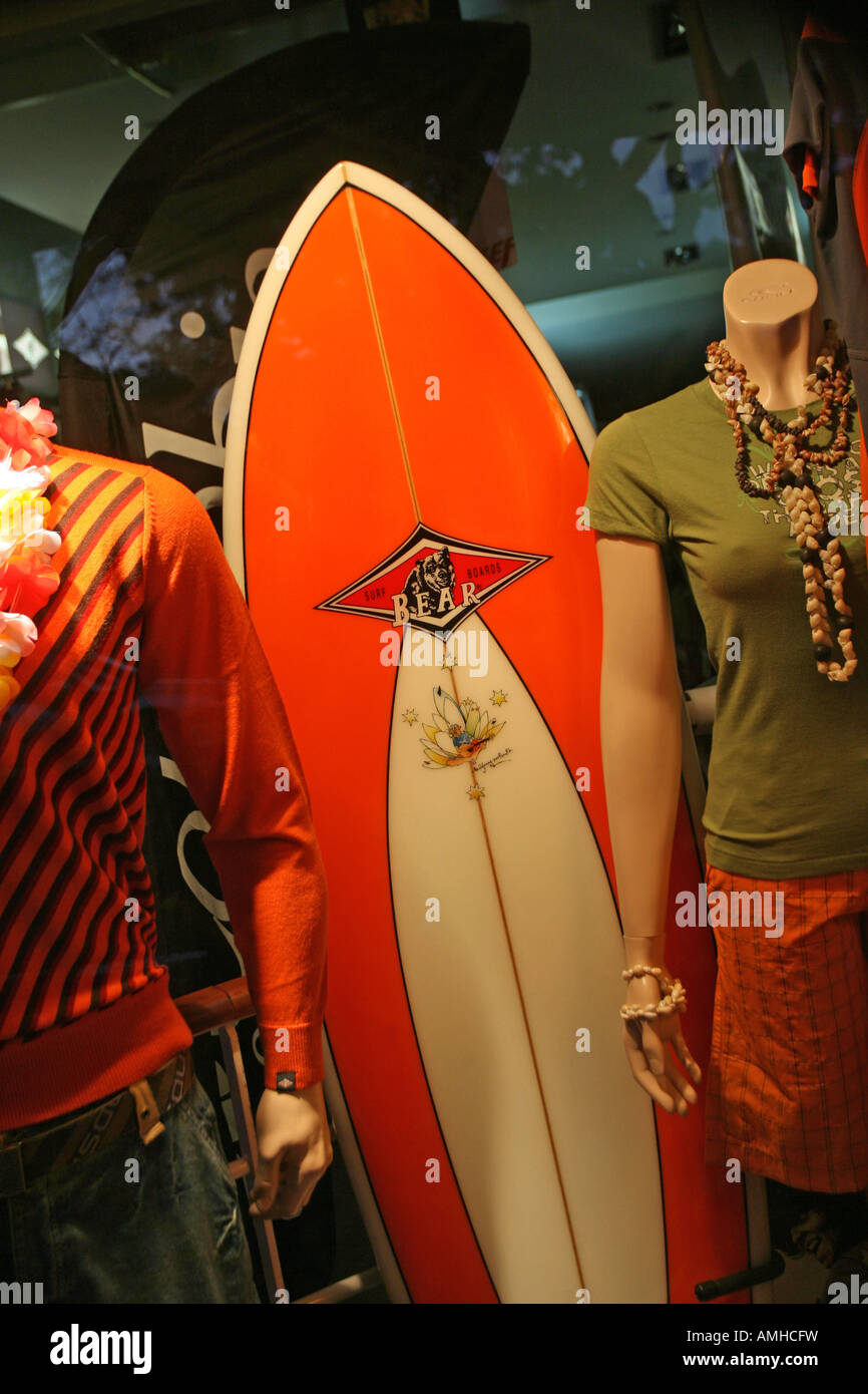 A Surfboard and Surf Clothing on display in a Surf Shop Window Stock ...