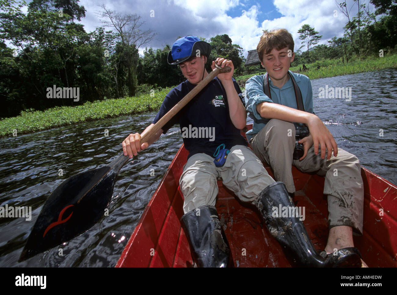 American high school students paddle canoe on oxbow lake in Peruvian ...