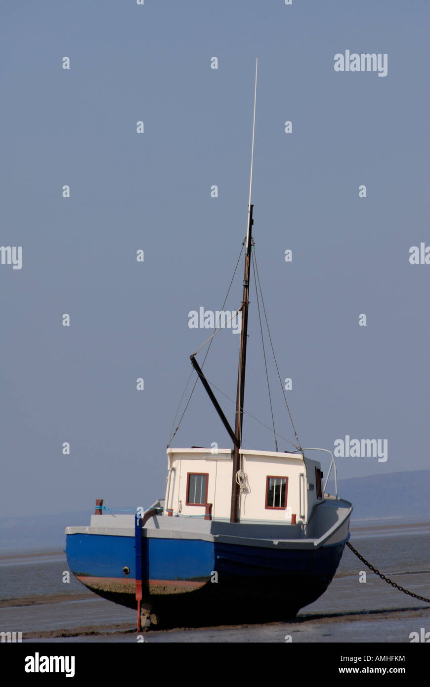 Small fishing boat anchored in Morecambe Bay Stock Photo - Alamy