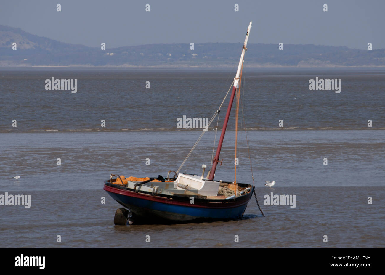 Small fishing boat anchored in Morecambe Bay Stock Photo - Alamy