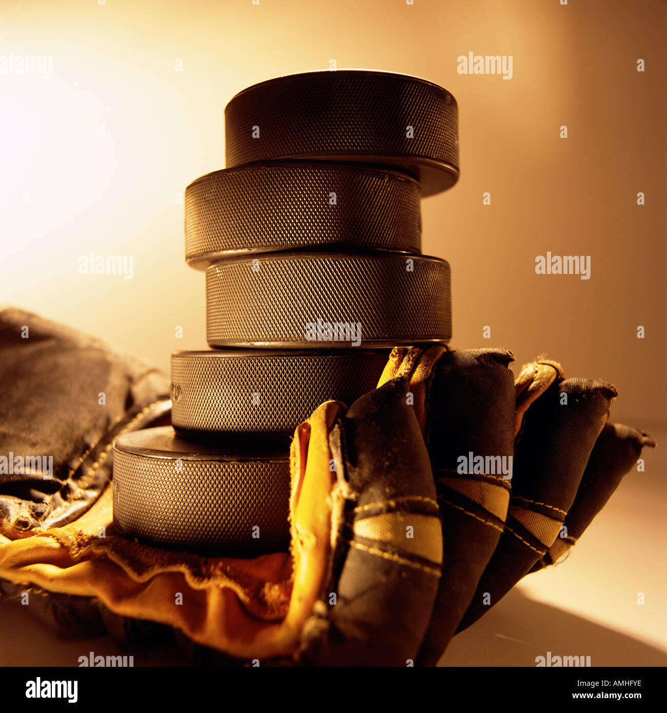 Stack of Hockey Pucks in Glove Stock Photo - Alamy