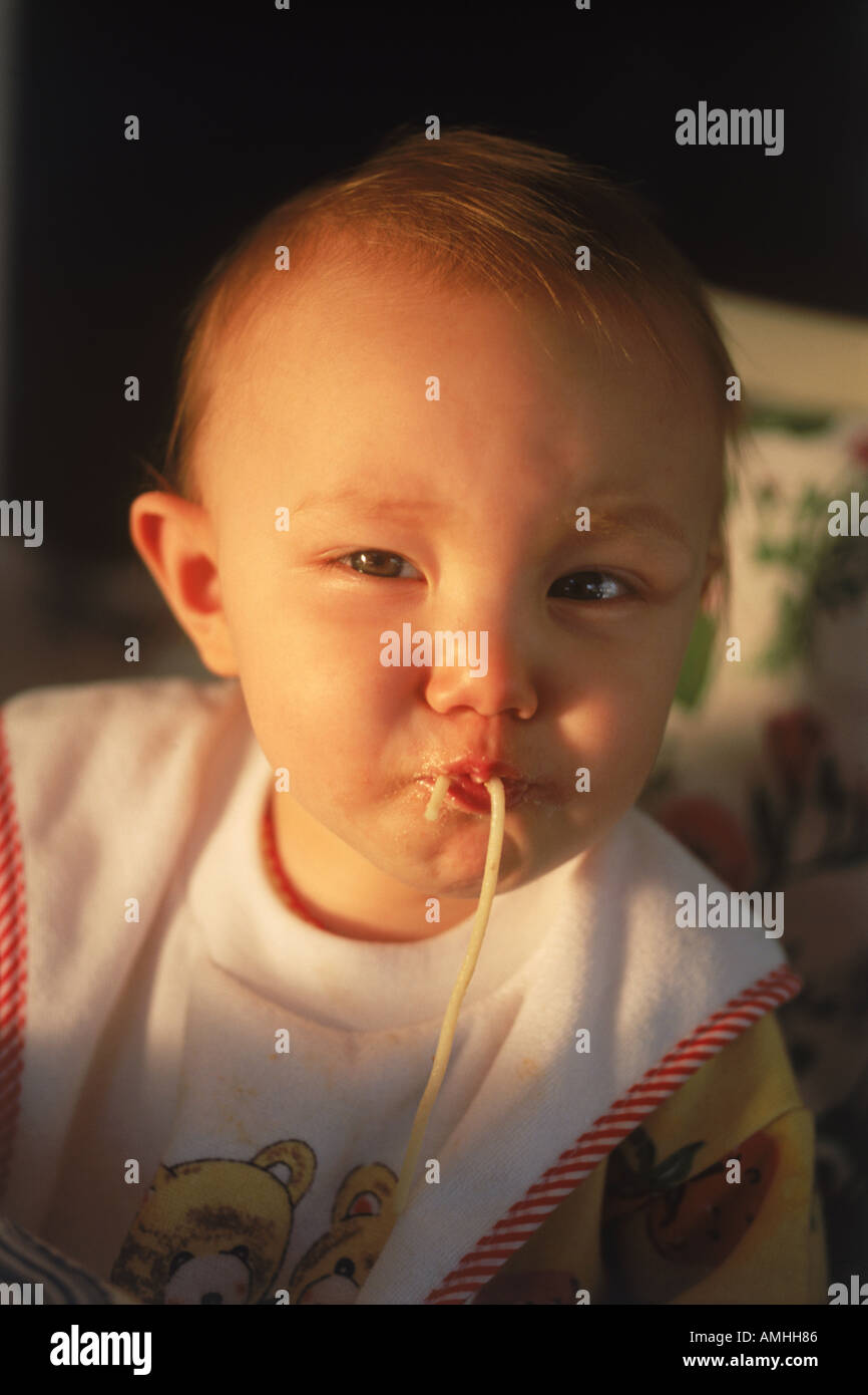 Baby eating spaghetti Stock Photo - Alamy