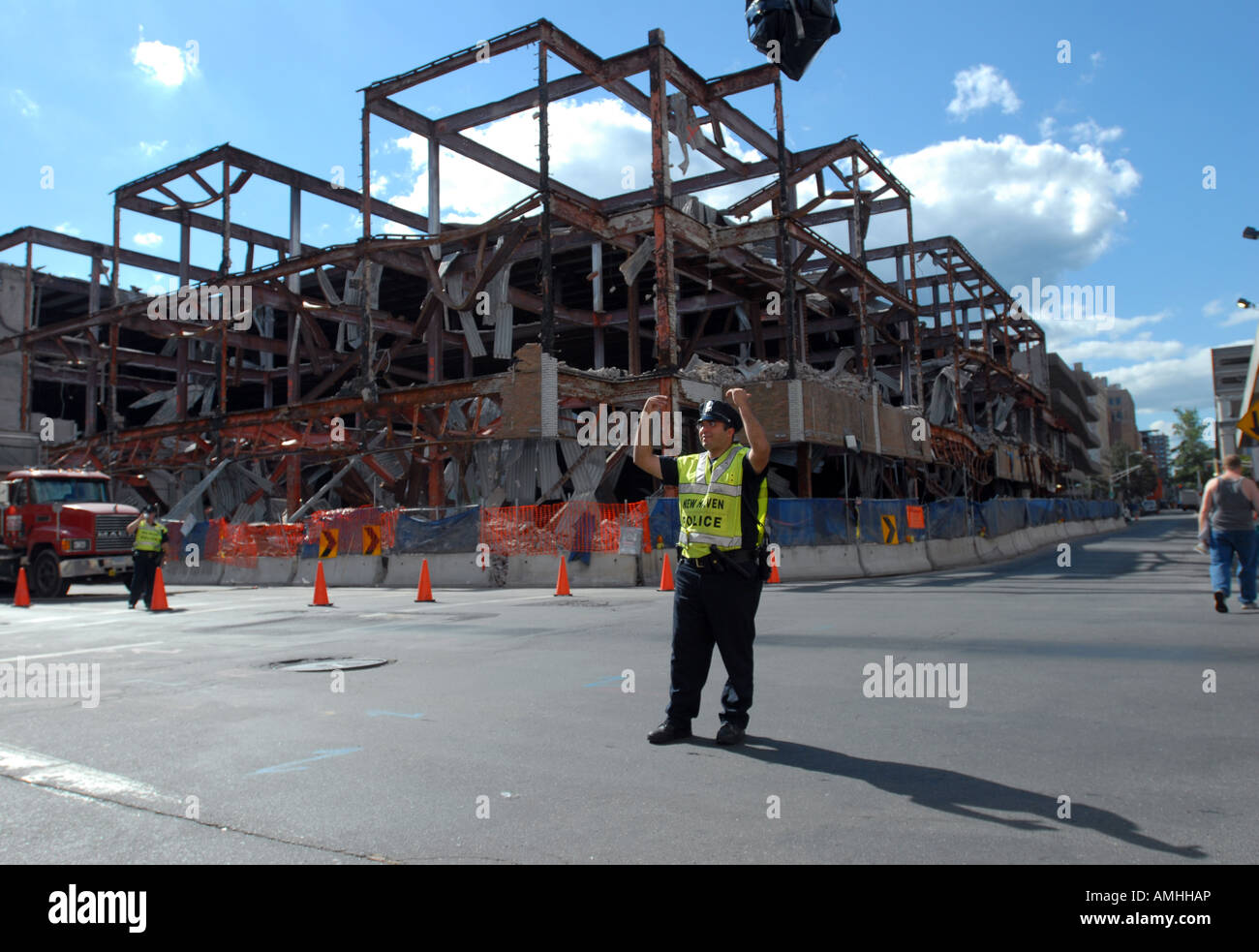 A New Haven Police Officer directs traffic as a massive demolition ...