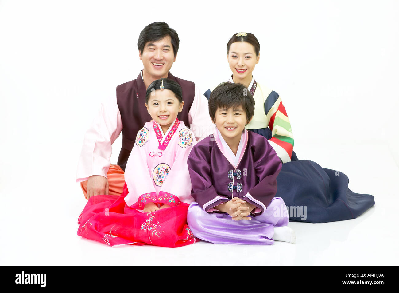 A family in Hanbok sitting in white background Stock Photo - Alamy