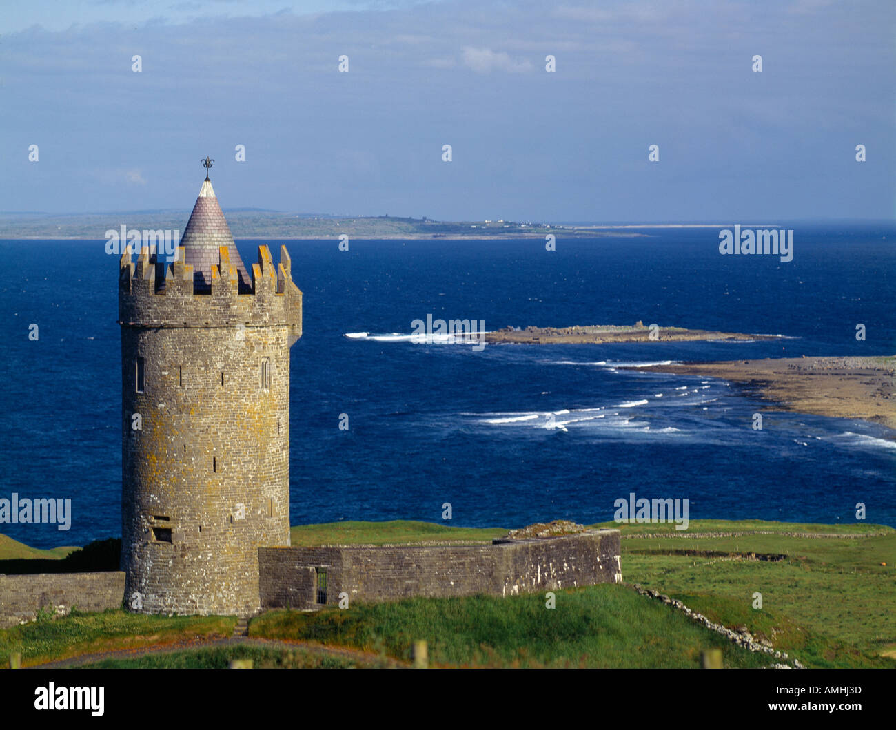 large round castle looking down on the storm atlantic ocean on irelands ...