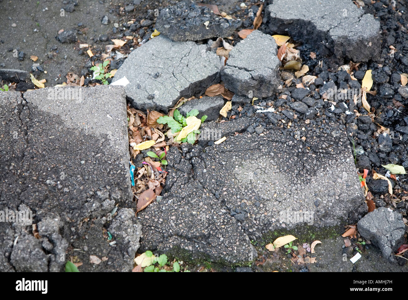 broken tarmac on a pavement Stock Photo - Alamy