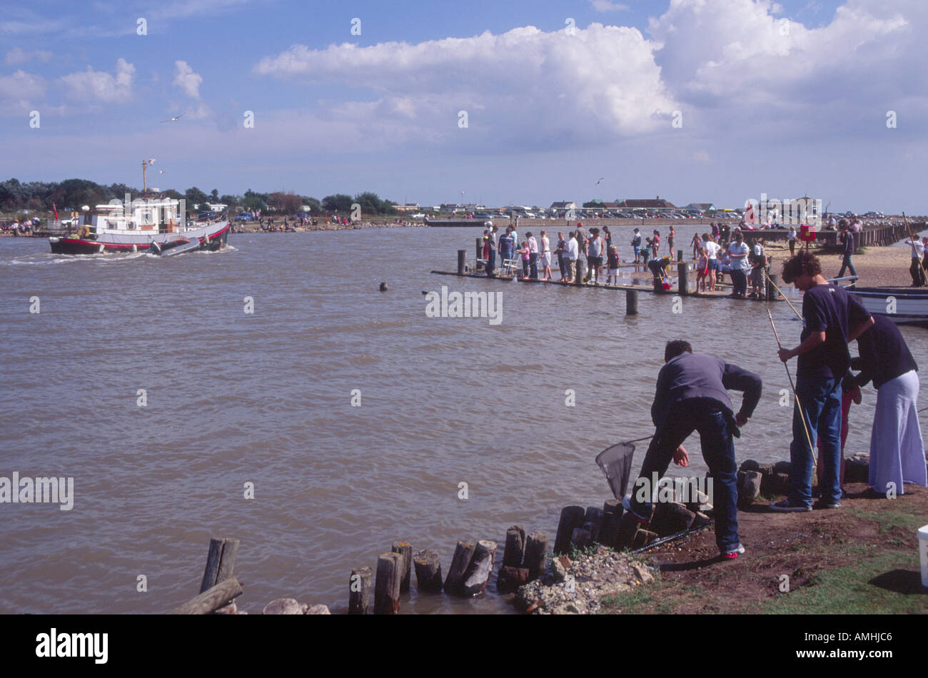 Fishing boat and people crabbing high tide River Blythe Walberswick ...