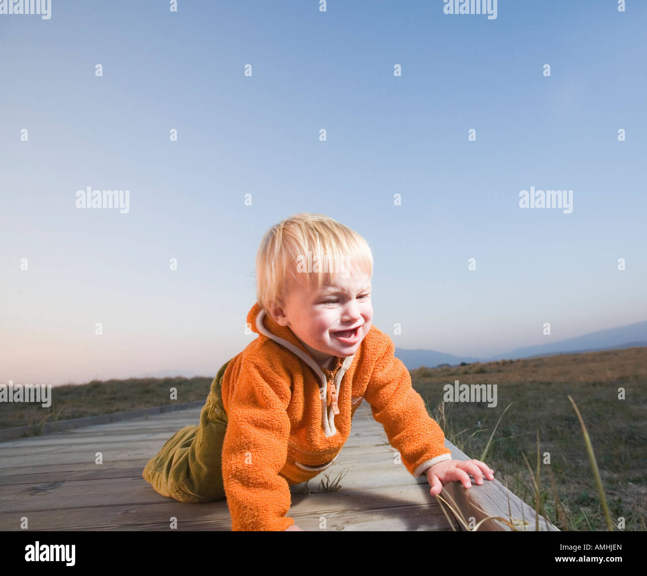 baby crying and crawling in nature Stock Photo - Alamy