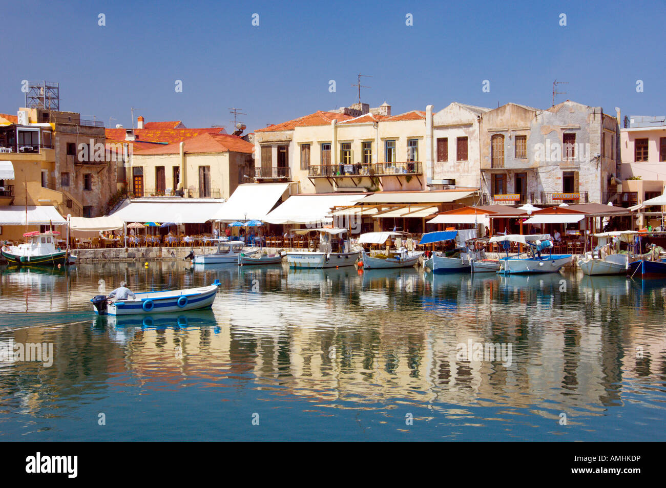 The Venetian harbour with colorful fishing boats in Rethymno Crete ...