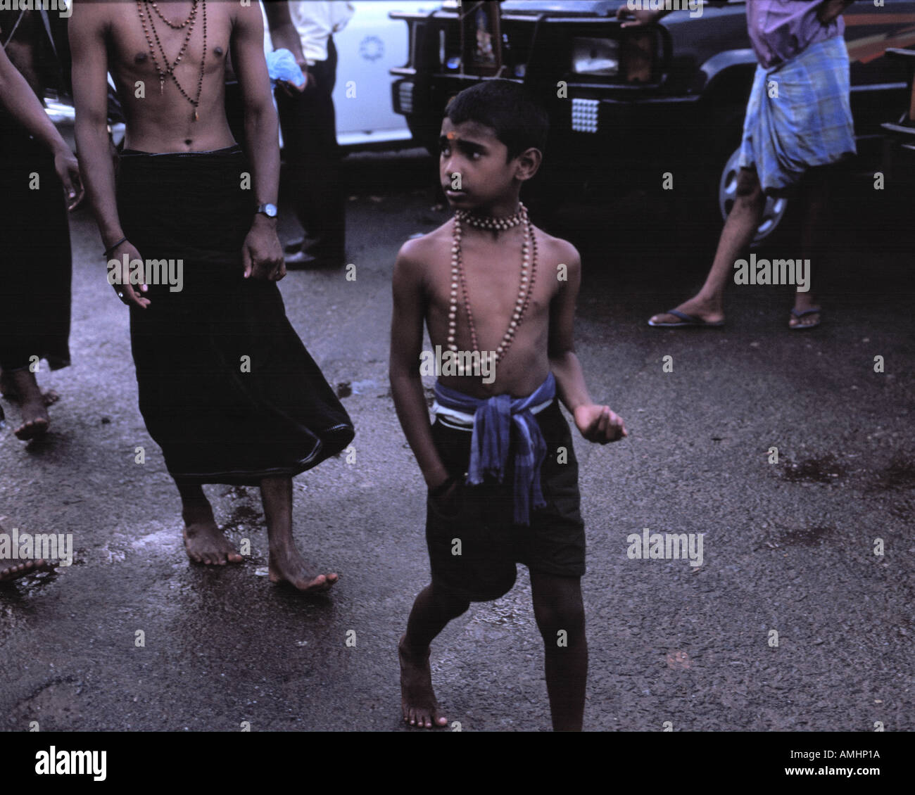 A young Indian boy in the late afternoon light arrives barefoot at the ...
