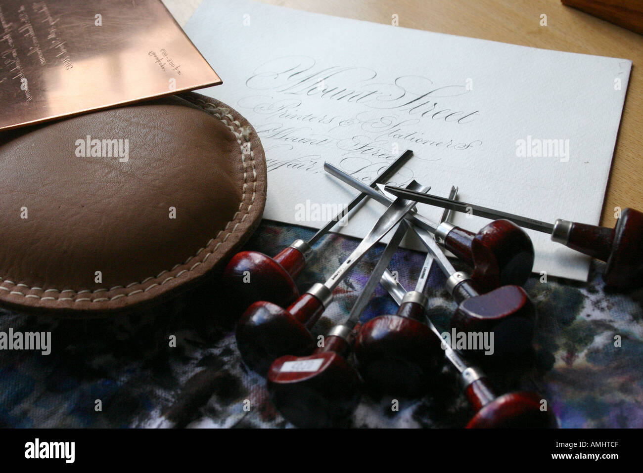 Engraving instruments strewn on a table Stock Photo - Alamy