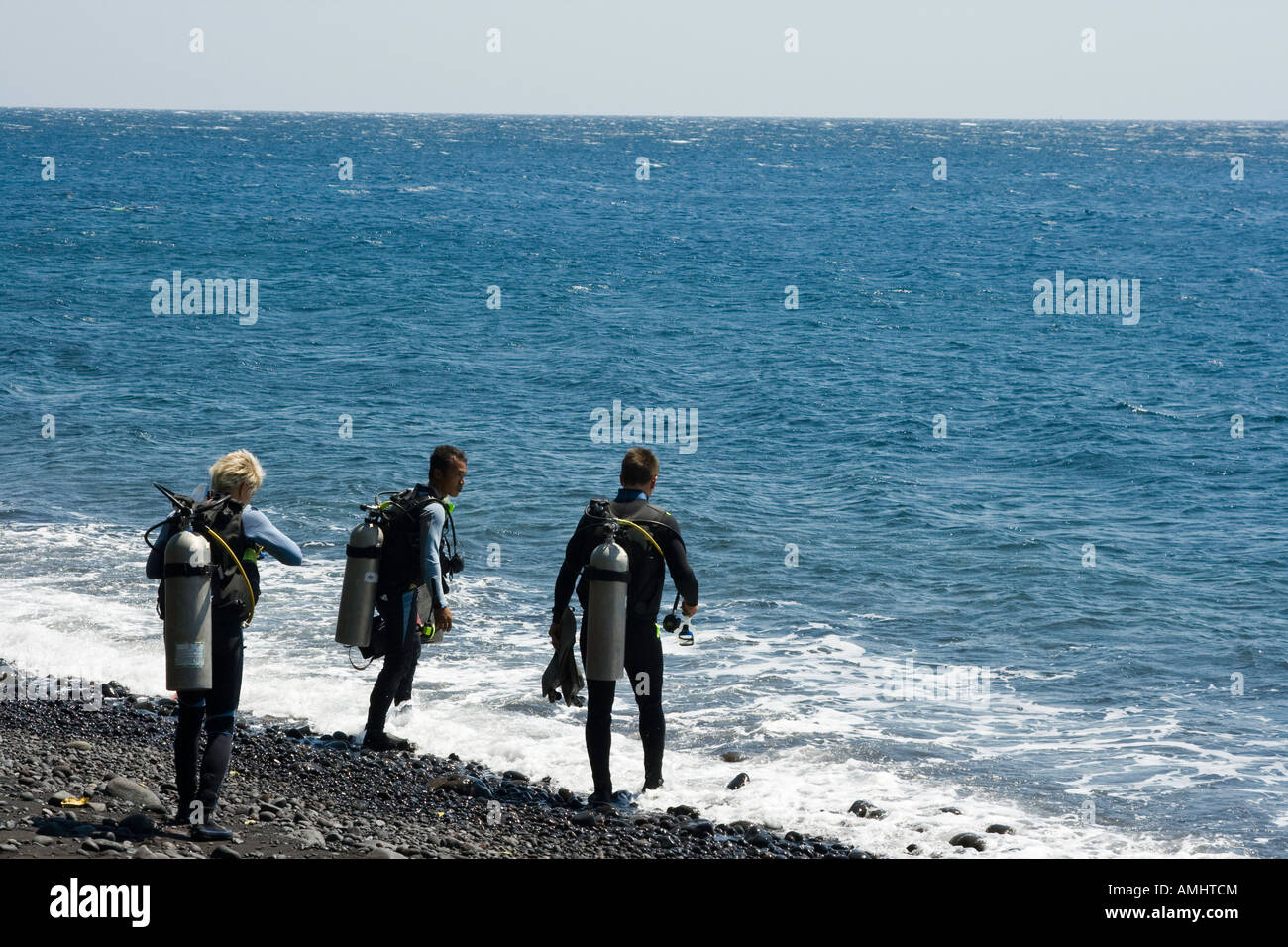 Divers entering the Ocean for the Liberty Wreck Dive Tulamben Bali ...