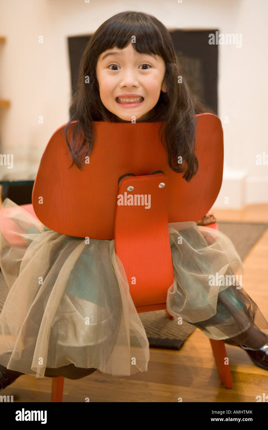 Child sitting in chair at home Stock Photo - Alamy