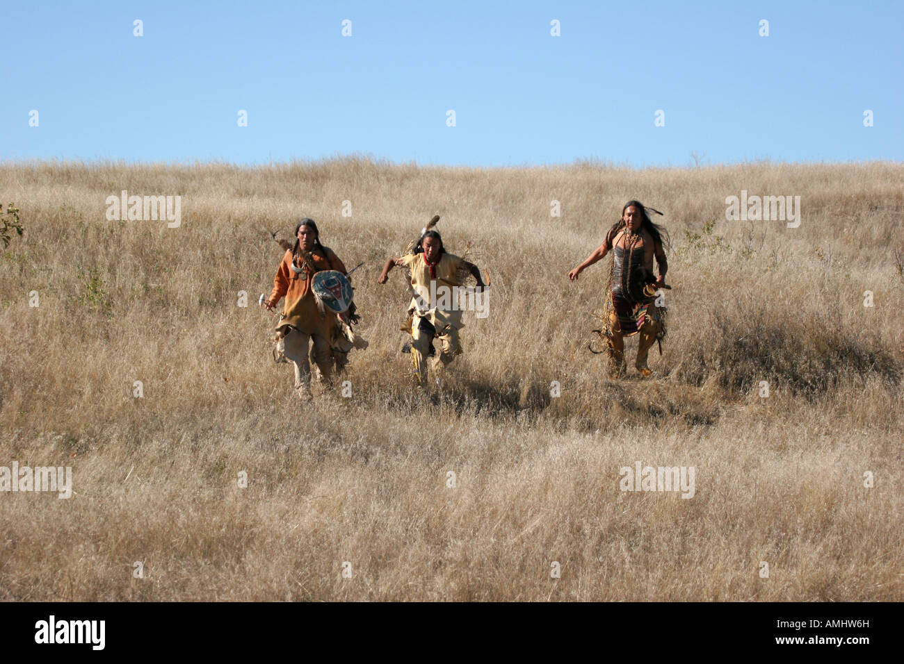 Three Native American Indian men running down a hill in pursuit of game ...