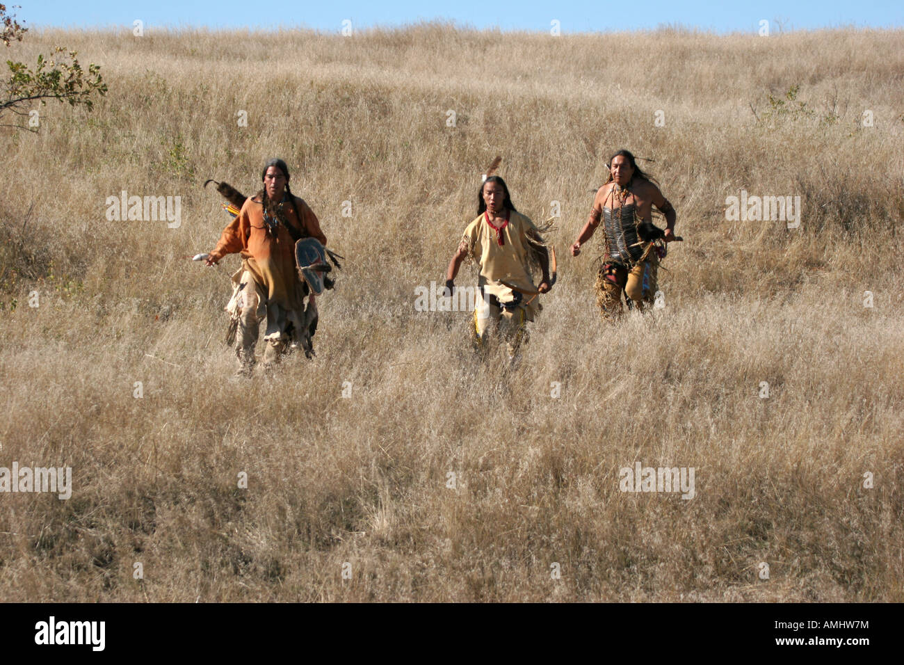 Three Native American Indian men running down a hill in pursuit of game ...
