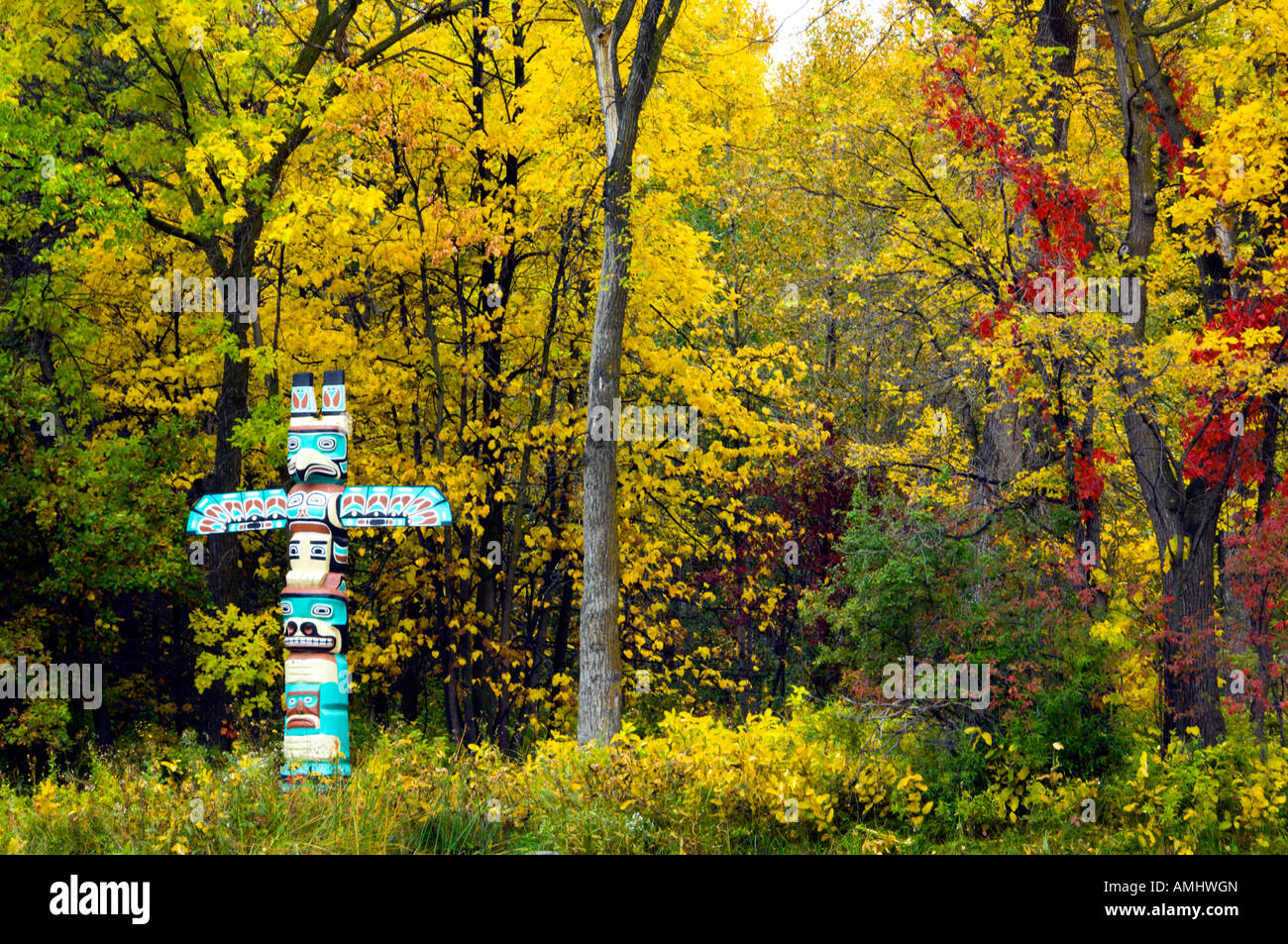 A totem pole with fall foliage color in St Vital Park in Winnipeg ...