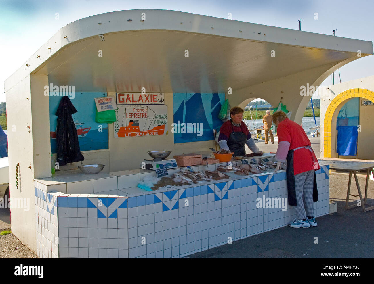 Fish stall on the quayside at Etaples France with two women Stock Photo ...
