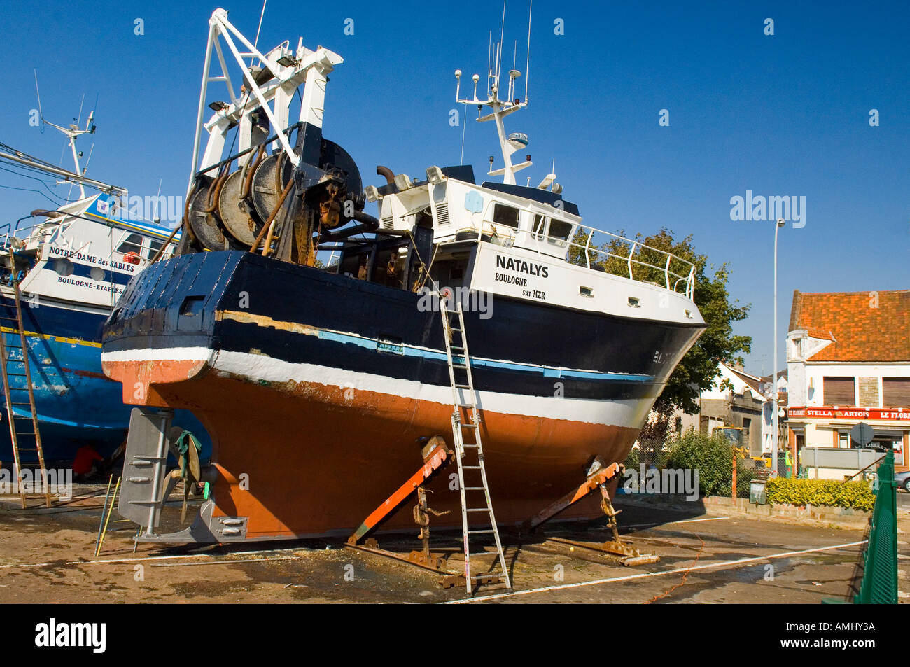 Fishing boats being repaired on the quayside at Etaples France Stock ...