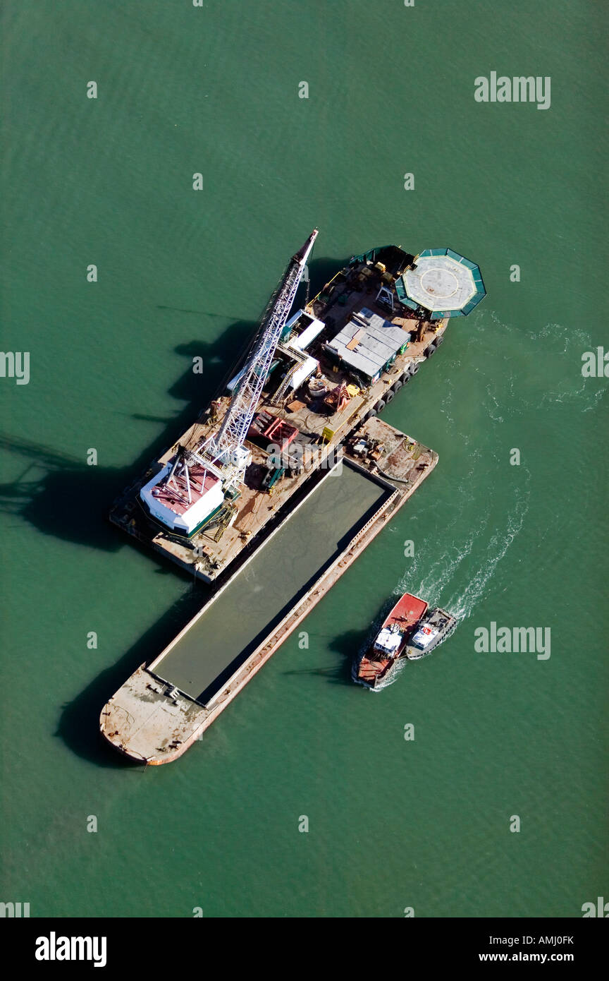 aerial above dredge barges and tug boats dredging the Port of Oakland estuary in San Francisco ...