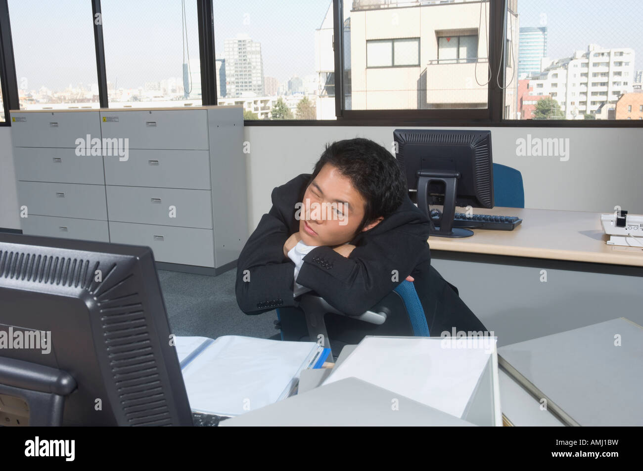 Businessman bored at office desk Stock Photo - Alamy