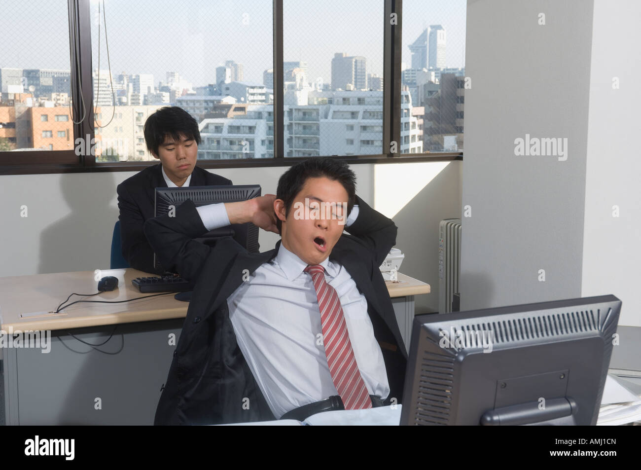 Businessman bored at office desk Stock Photo - Alamy