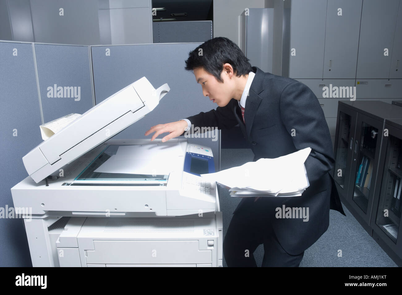 Businessman using photocopier Stock Photo - Alamy