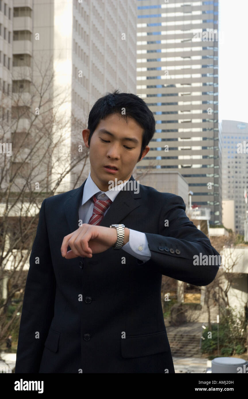 Businessman checking the time Stock Photo - Alamy